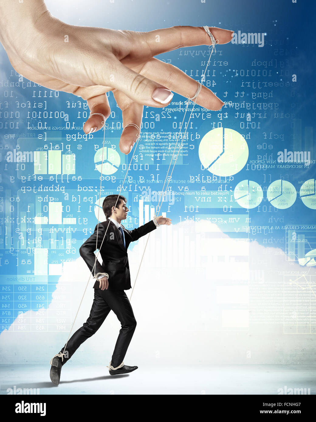 Businessman marionette on ropes controlled by puppeteer against diagram ...