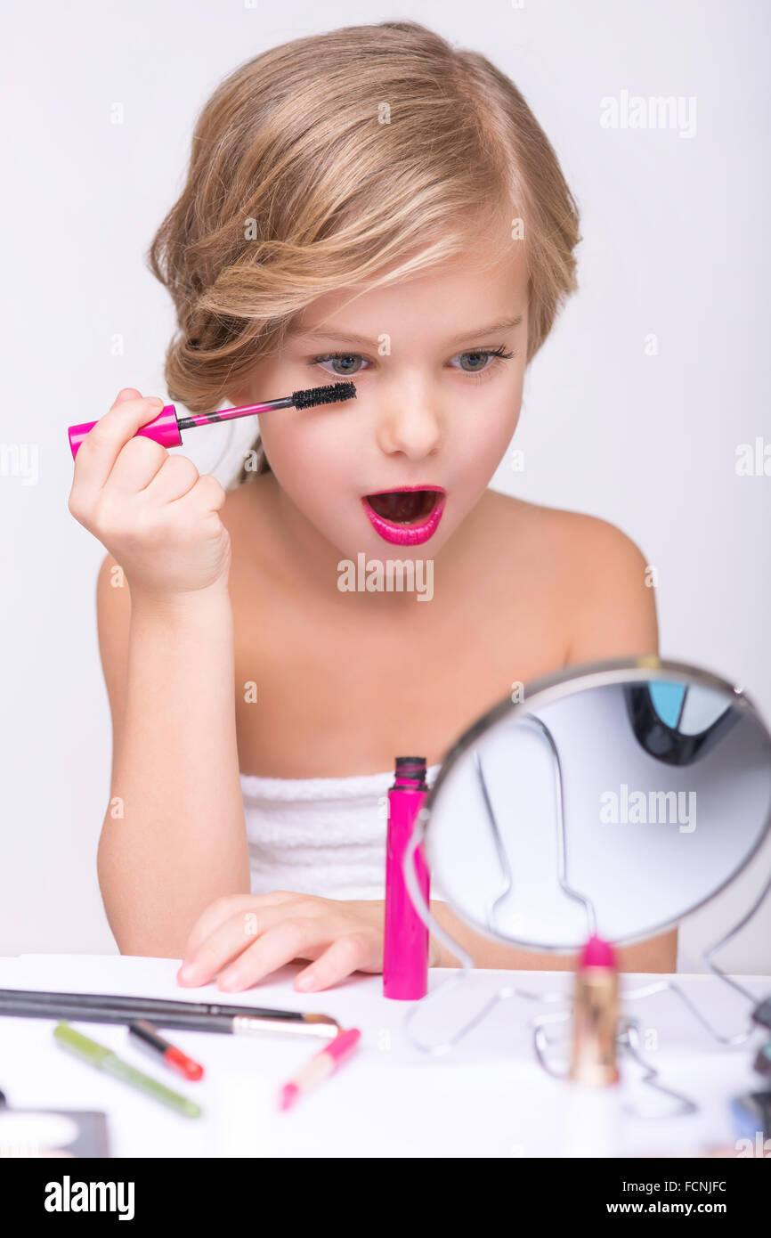 Nice little girl doing make up Stock Photo - Alamy