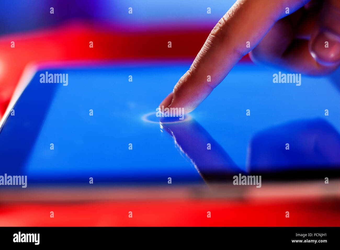 Close-up image of finger touching blue screen Stock Photo - Alamy