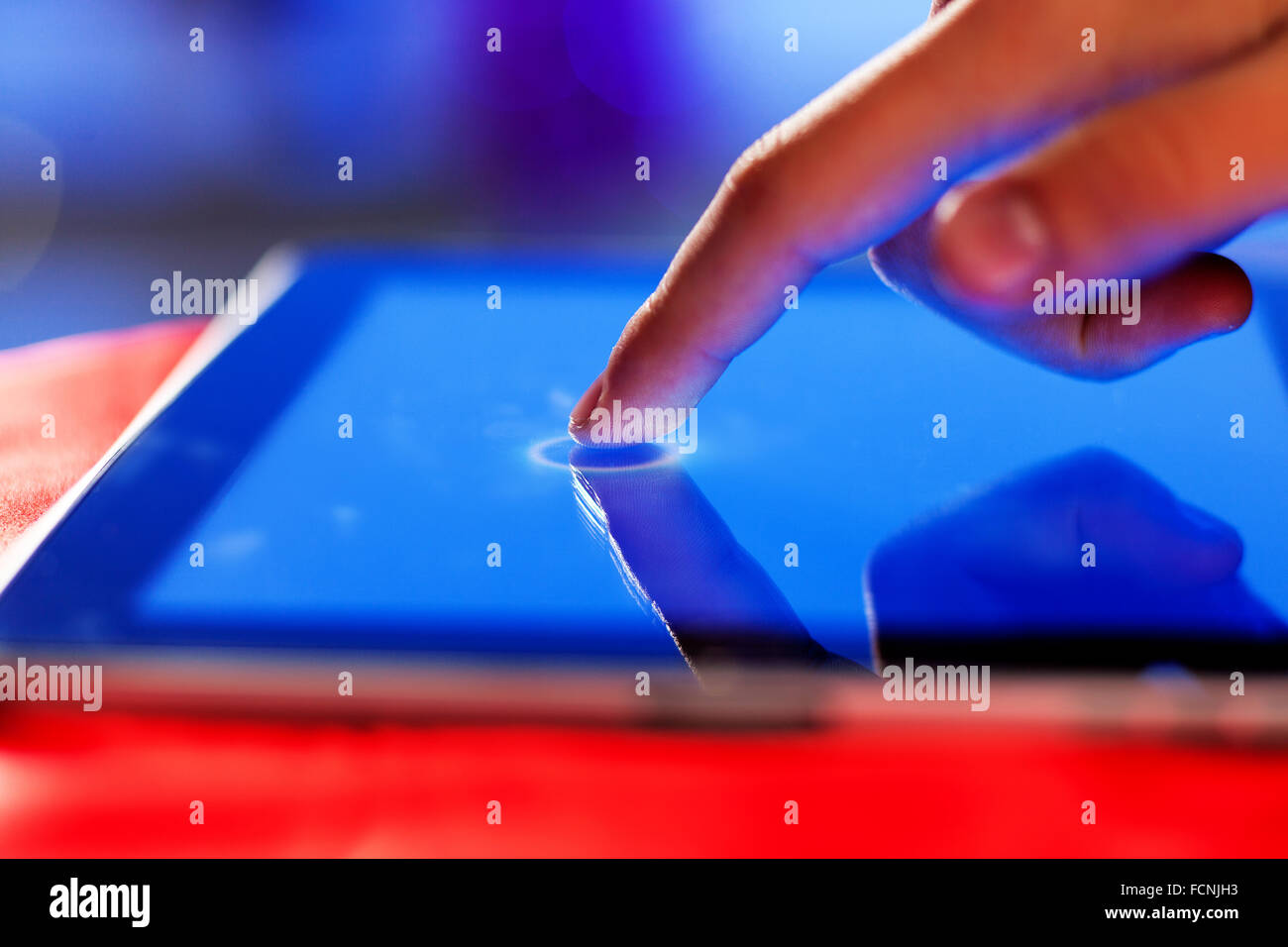 Close-up image of finger touching blue screen Stock Photo - Alamy