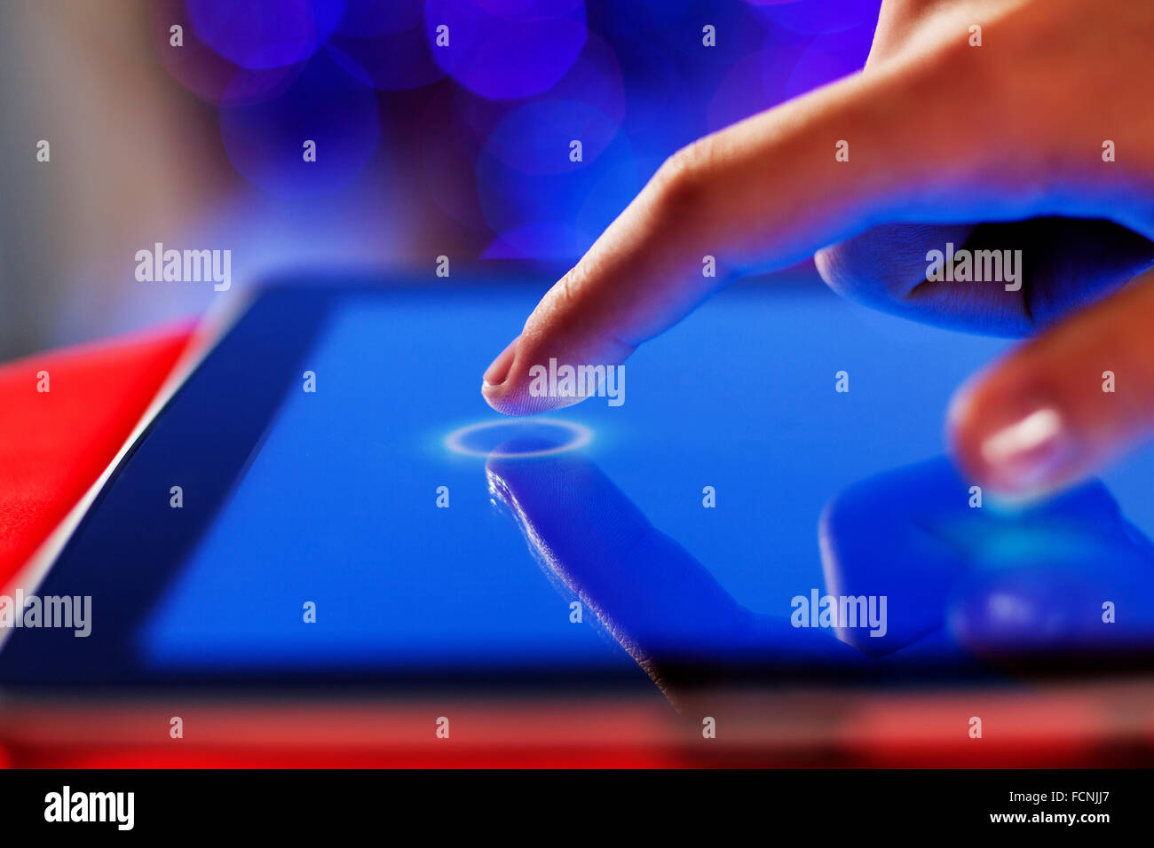 Close-up image of finger touching blue screen Stock Photo - Alamy