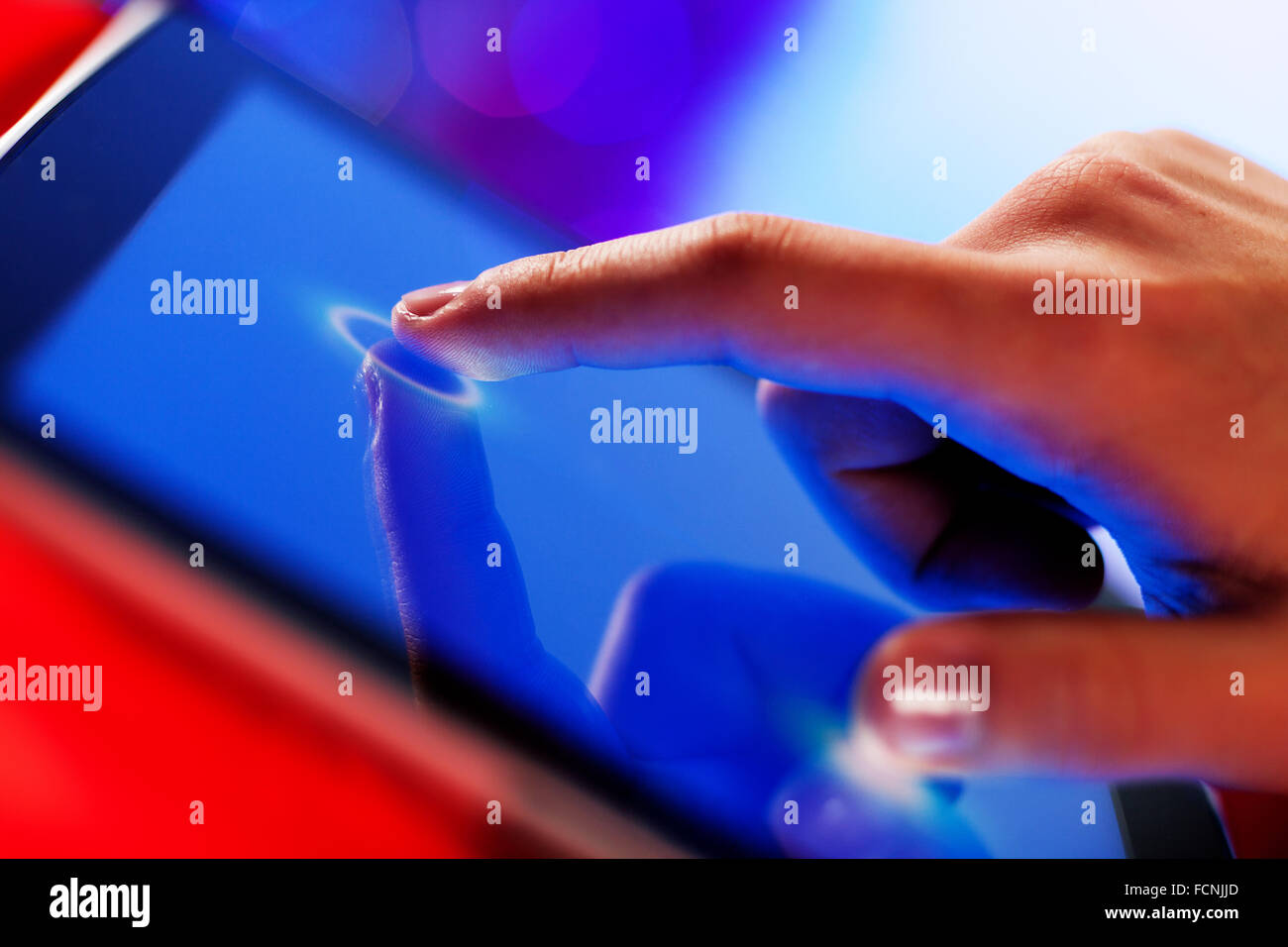 Close-up image of finger touching blue screen Stock Photo - Alamy