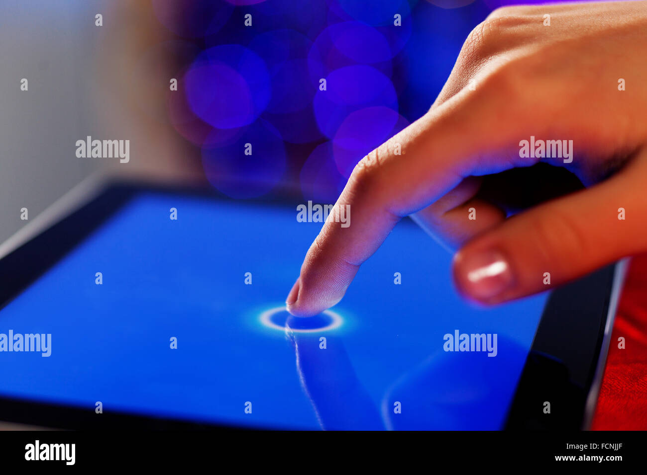 Close-up image of finger touching blue screen Stock Photo - Alamy
