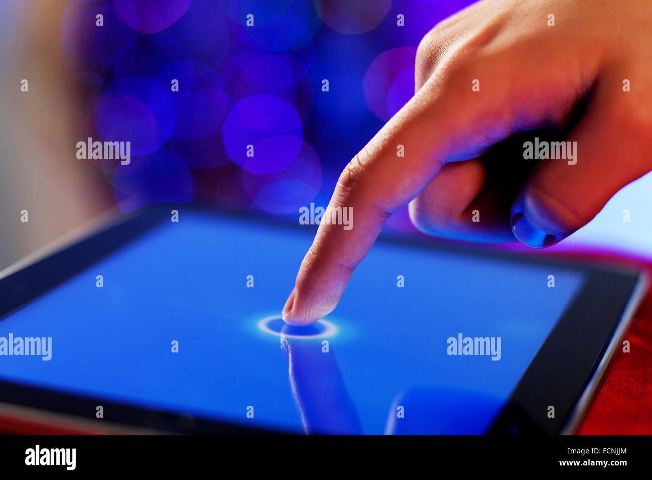 Close-up image of finger touching blue screen Stock Photo - Alamy