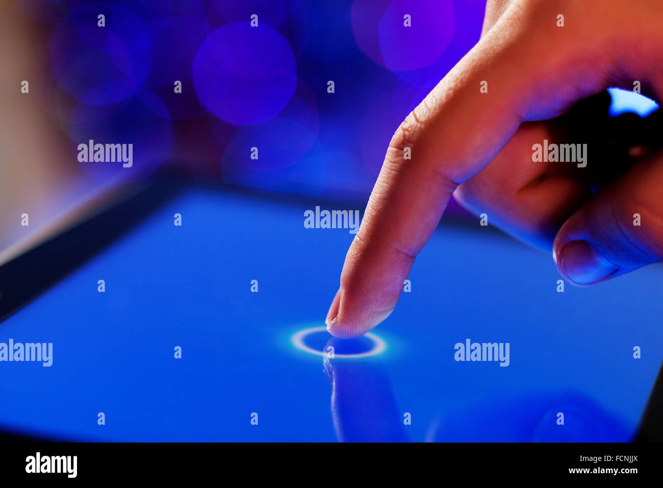 Close-up image of finger touching blue screen Stock Photo - Alamy