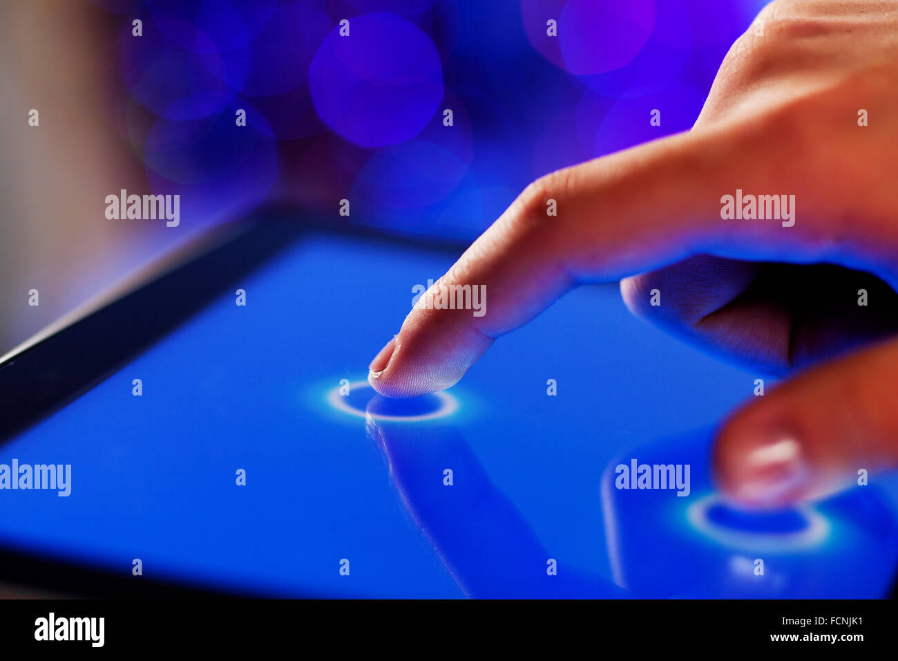 Close-up image of finger touching blue screen Stock Photo - Alamy