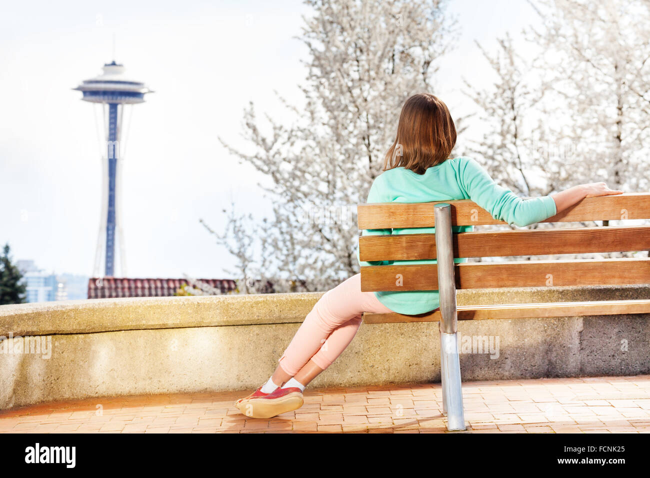 Young woman on bench look at space needle Stock Photo - Alamy