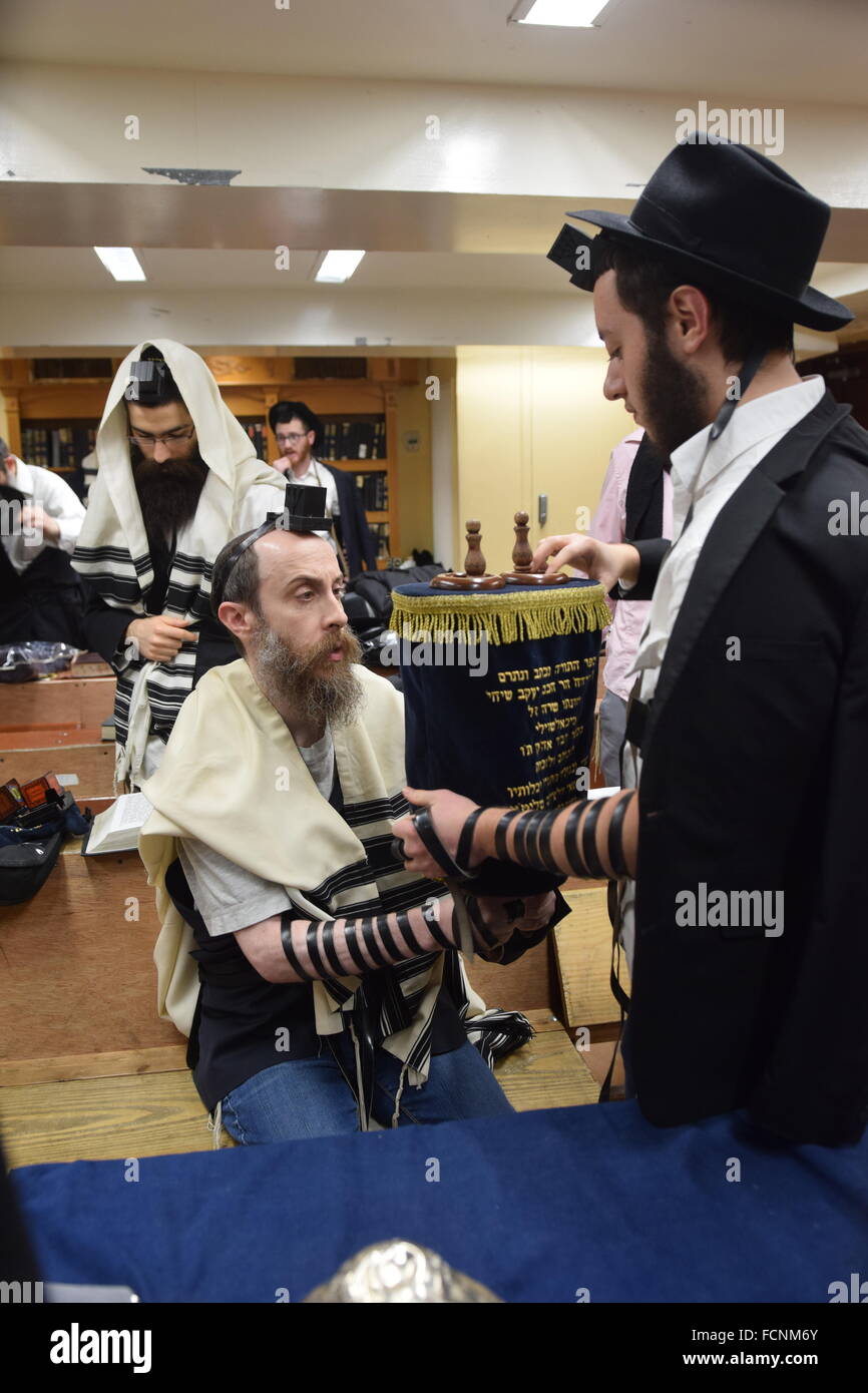 After a reading, a Torah scroll covered in preparation for being ...