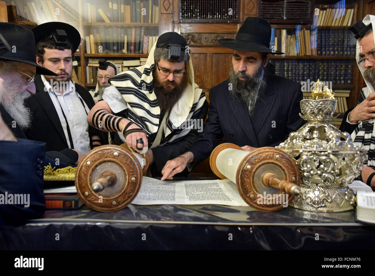 A religious Jewish man perpares to recite a blessing before a Torah ...