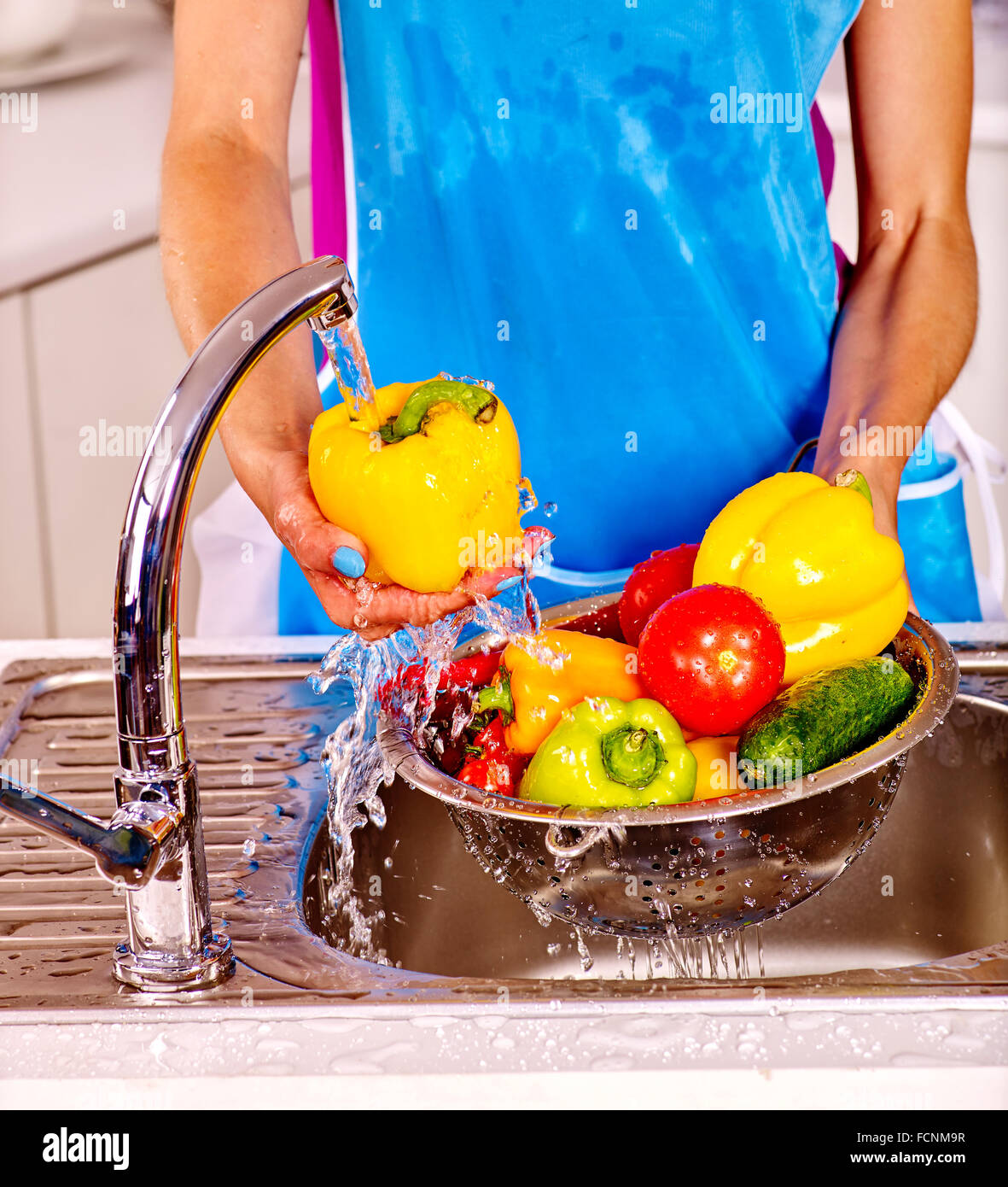 Woman washing fruit at kitchen Stock Photo - Alamy