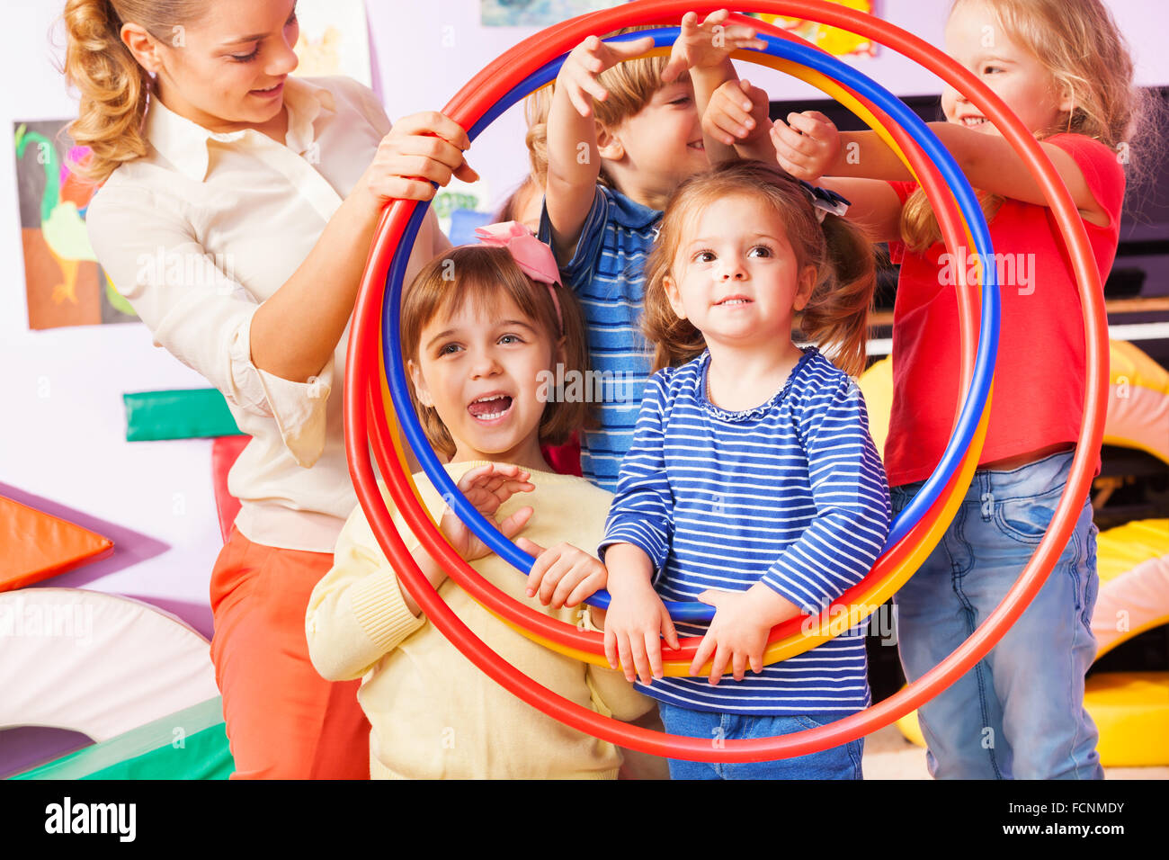 Kids boys and girls look though hoop Stock Photo - Alamy