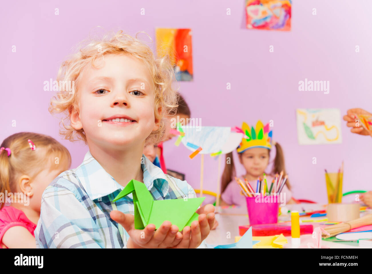 Kids in kindergarten make origami, portrait of boy Stock Photo - Alamy