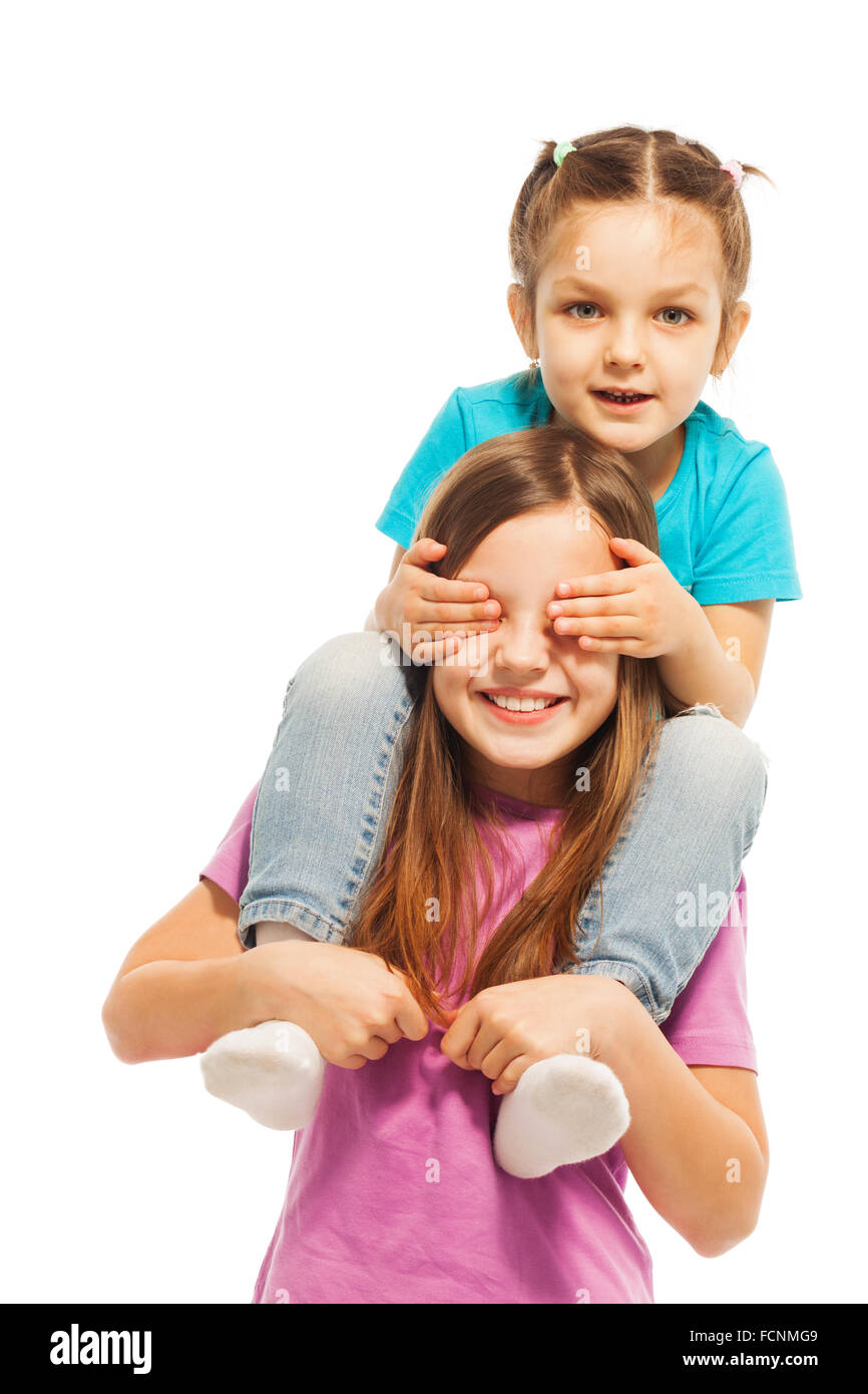 Little sister sitting on elder sister's shoulders Stock Photo - Alamy