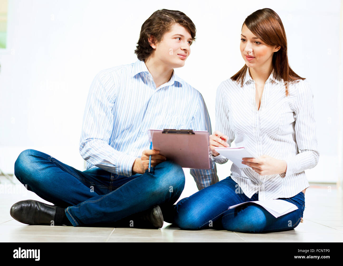 Image of two students discussing their work Stock Photo - Alamy