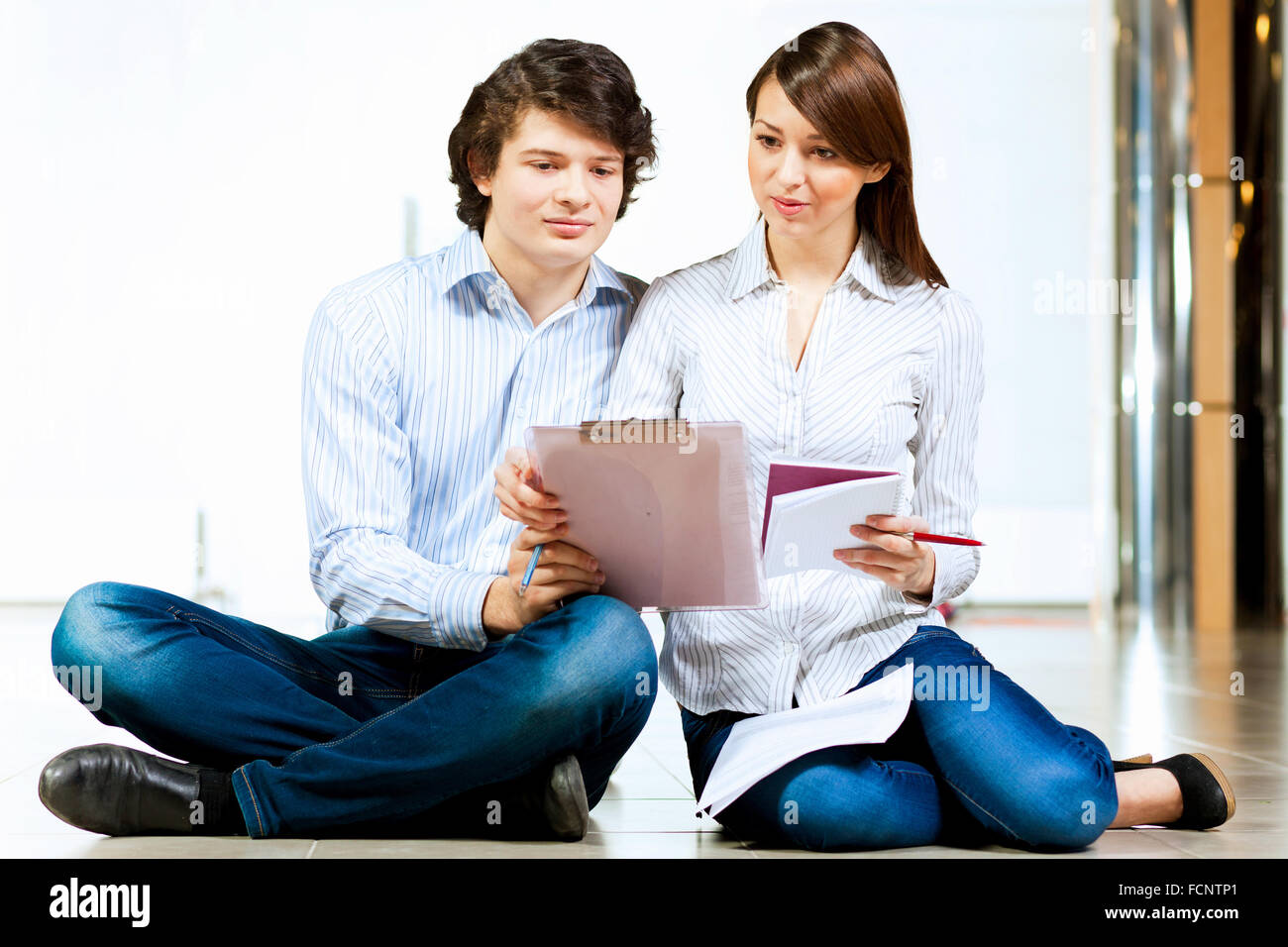 Image of two students discussing their work Stock Photo - Alamy
