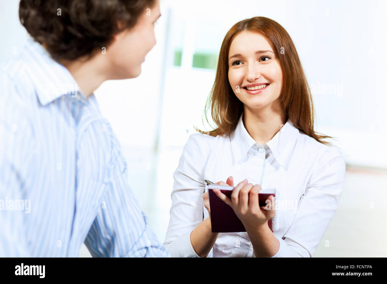 Image of two students discussing their work Stock Photo - Alamy