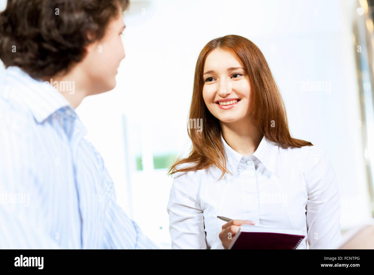 Image of two students discussing their work Stock Photo - Alamy
