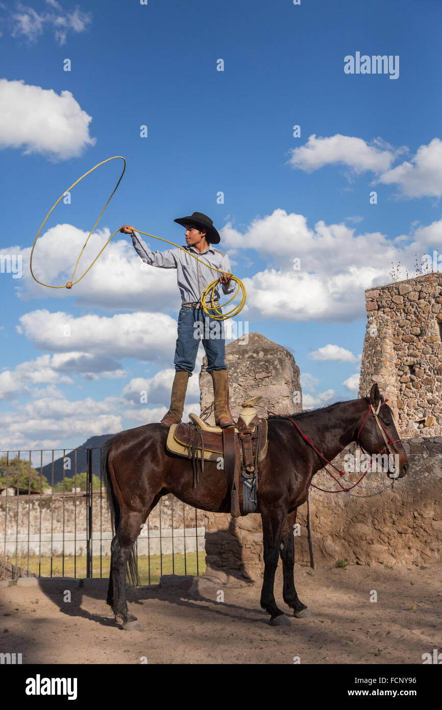 A Mexican charro or cowboy practices roping skills on his horse before ...