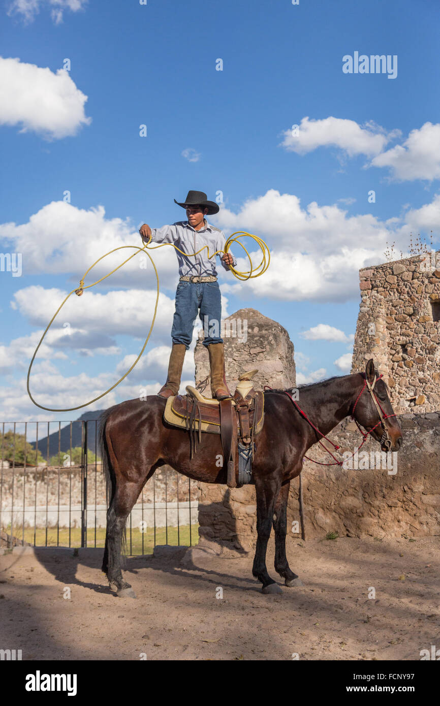 A Mexican charro or cowboy practices roping skills on his horse before ...