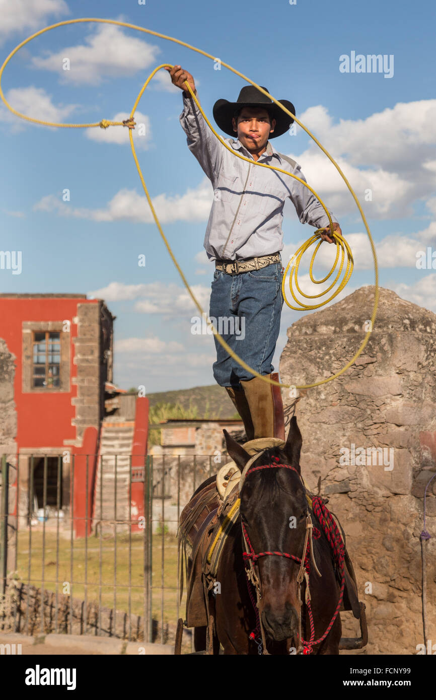 A Mexican charro or cowboy practices roping skills on his horse before ...