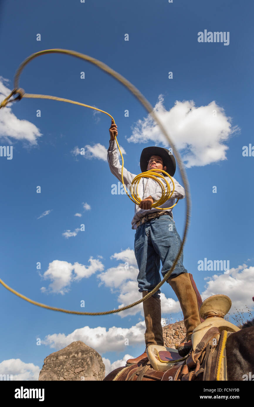 A Mexican charro or cowboy practices roping skills on his horse before ...