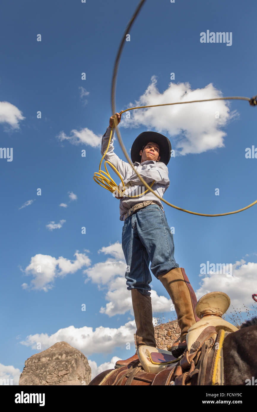 A Mexican charro or cowboy practices roping skills on his horse before ...
