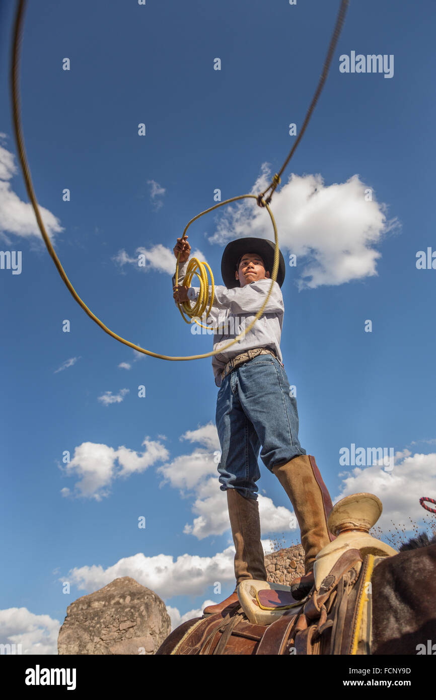 A Mexican charro or cowboy practices roping skills on his horse before ...