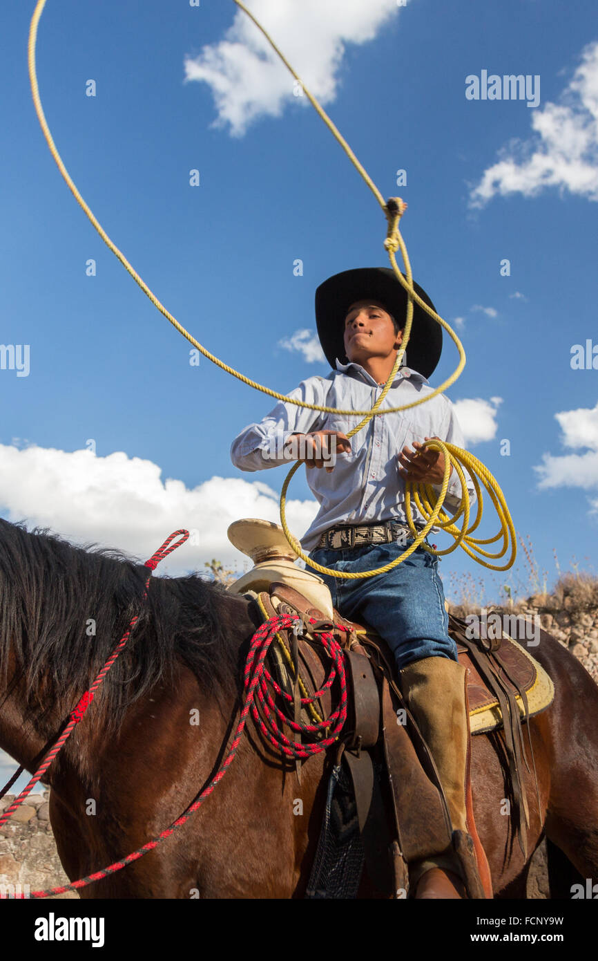 A Mexican charro or cowboy practices roping skills on his horse before ...