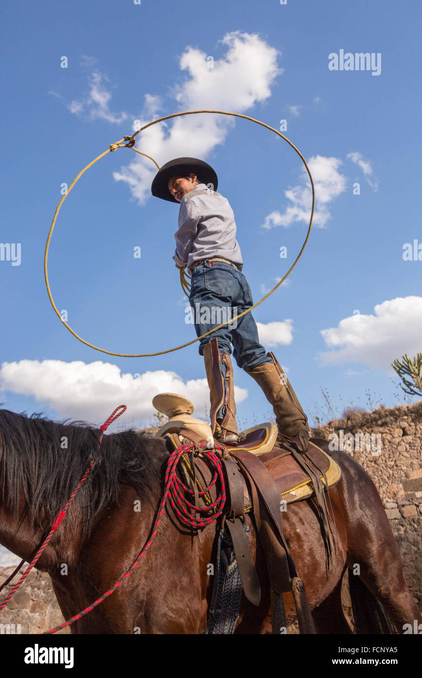 A Mexican charro or cowboy practices roping skills on his horse before ...