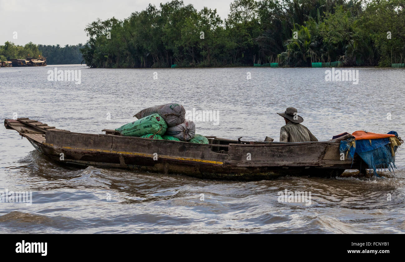 Boats carry goods on the Mekong Delta for local and national use the ...