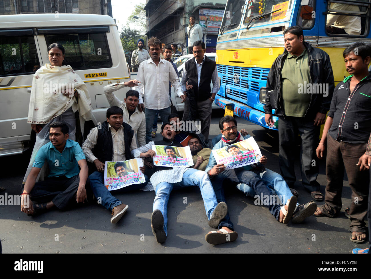 Kolkata, India. 23rd Jan, 2016. People sitting while holding banners ...