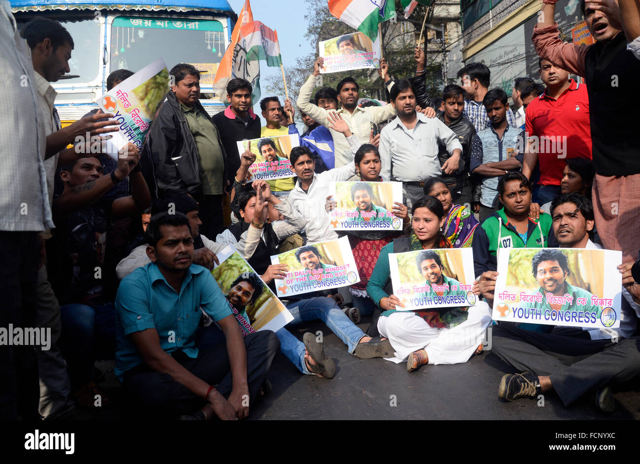 Kolkata, India. 23rd Jan, 2016. People sitting while holding banners ...