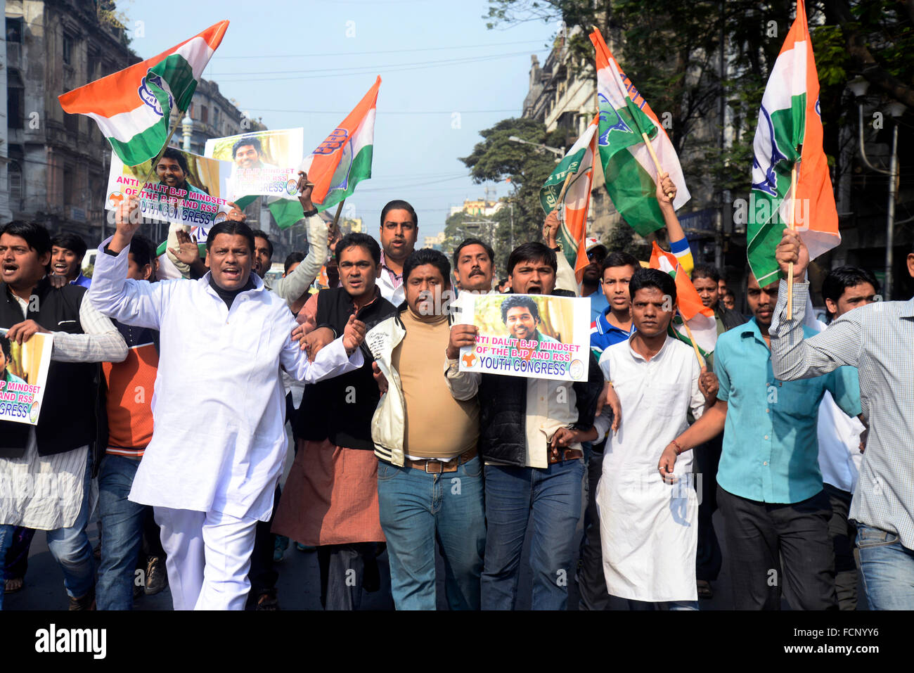 Kolkata, India. 23rd Jan, 2016. People walking while holding flags ...