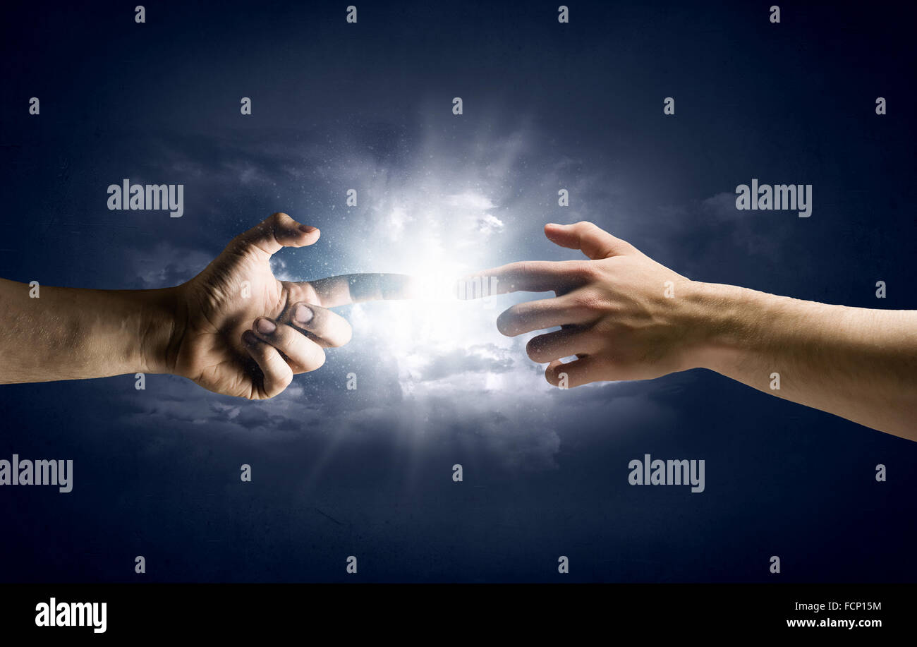 Close up of two hands reaching each other with fingers Stock Photo - Alamy