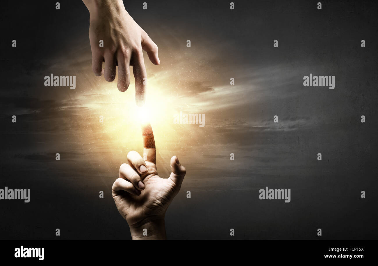 Close up of two hands reaching each other with fingers Stock Photo - Alamy