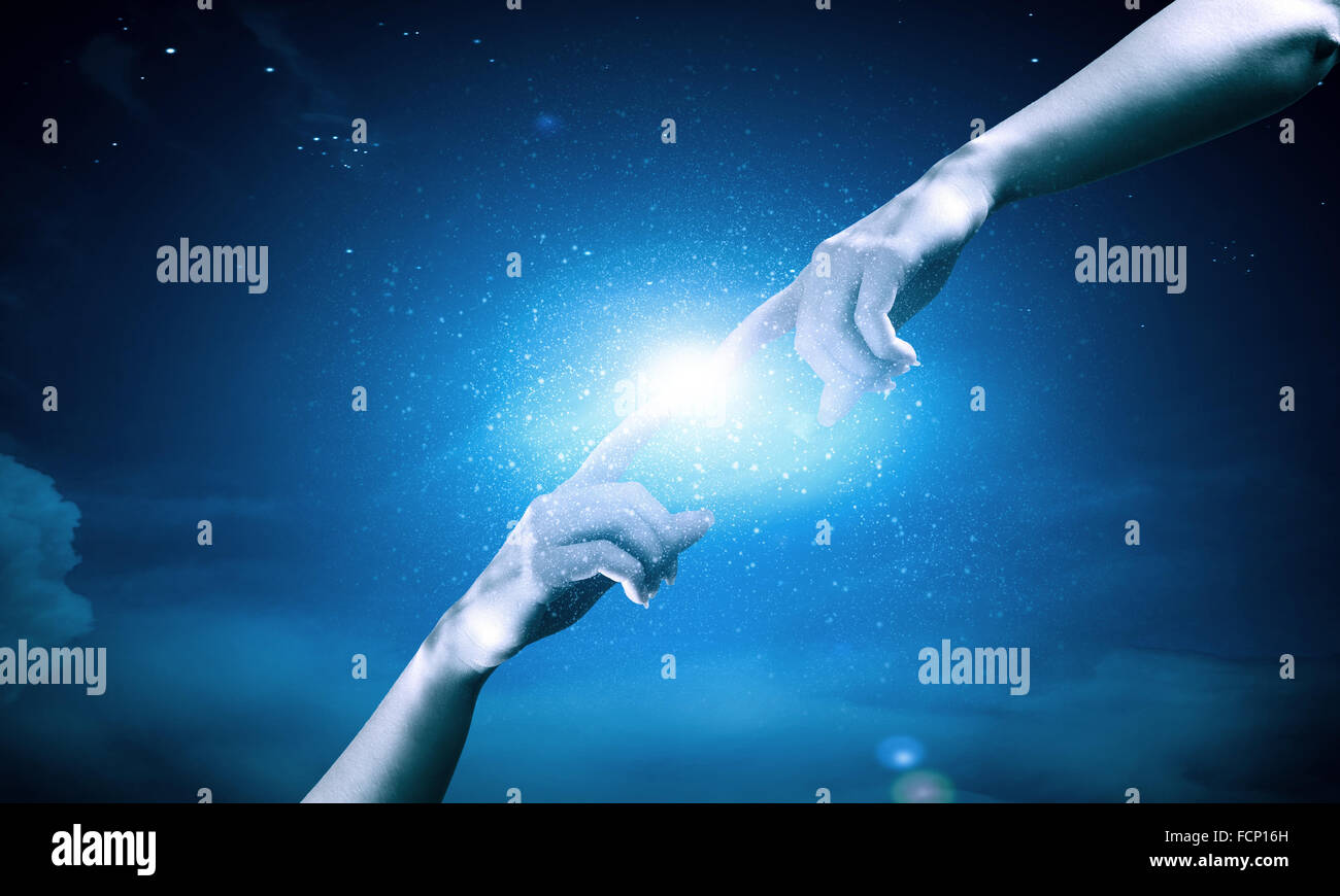 Close up of two hands reaching each other with fingers Stock Photo - Alamy