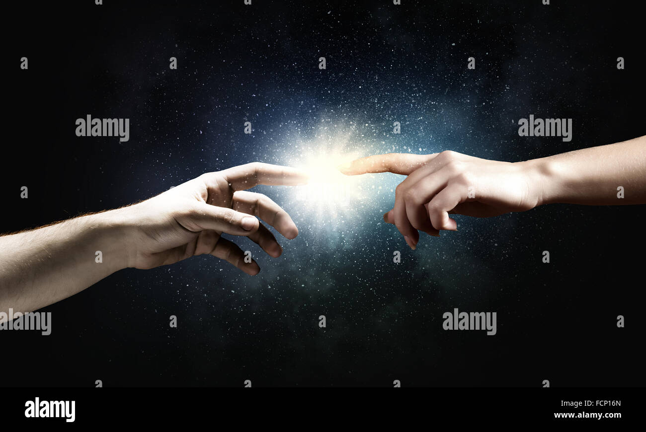 Close up of two hands reaching each other with fingers Stock Photo - Alamy