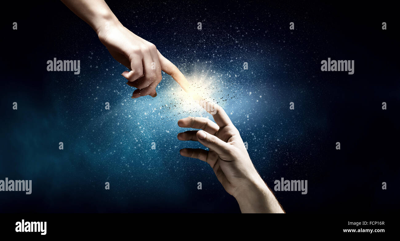 Close up of two hands reaching each other with fingers Stock Photo - Alamy