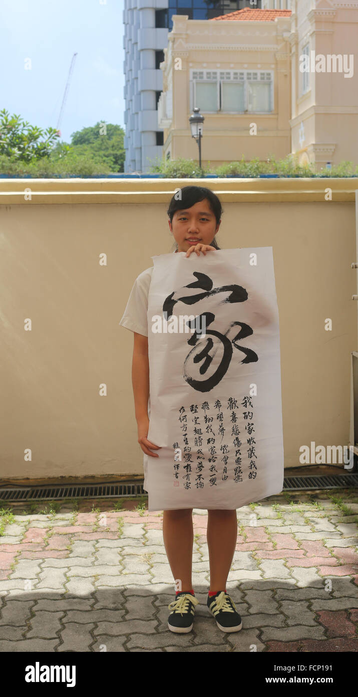 Singapore. 23rd Jan, 2016. A student presents her calligraphy work at ...