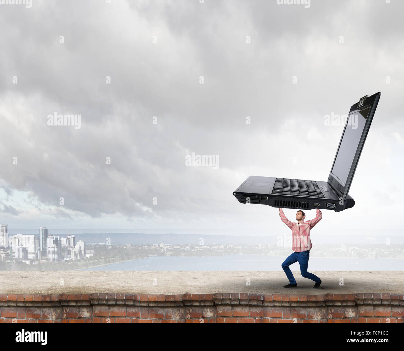 Young man in casual carrying big laptop on back Stock Photo - Alamy
