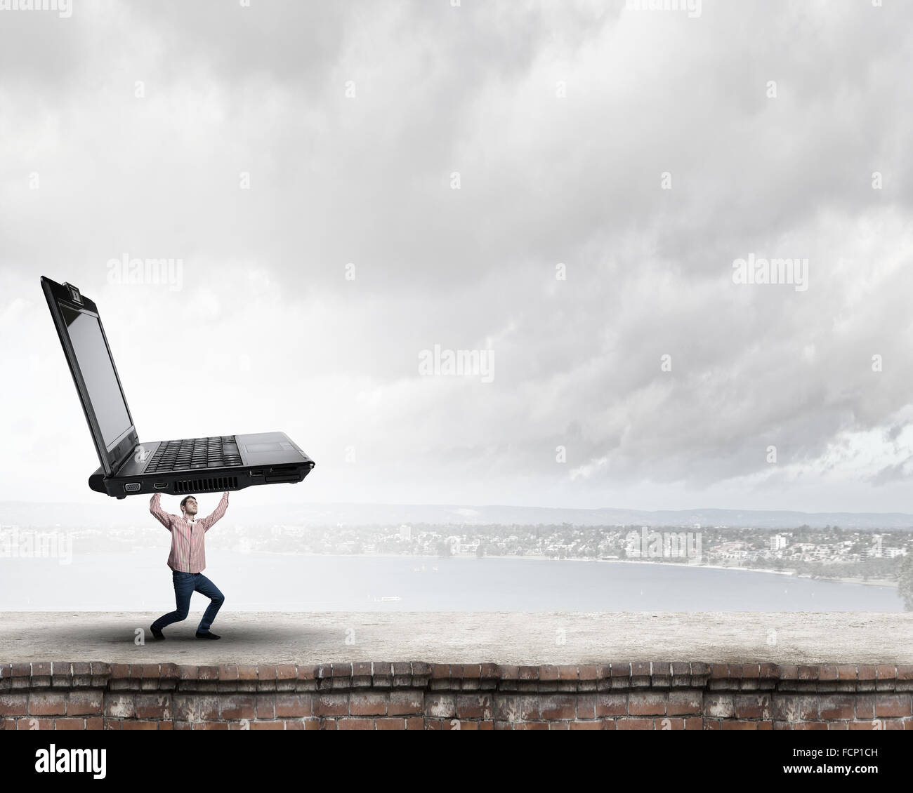 Young man in casual carrying big laptop on back Stock Photo - Alamy