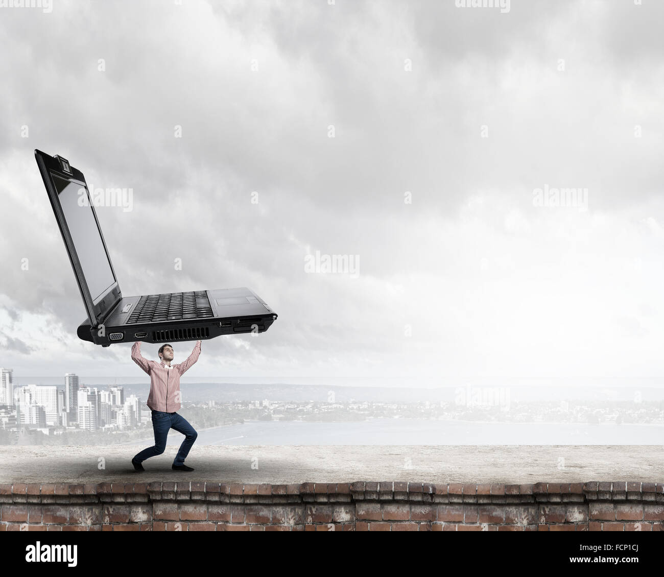 Young man in casual carrying big laptop on back Stock Photo - Alamy