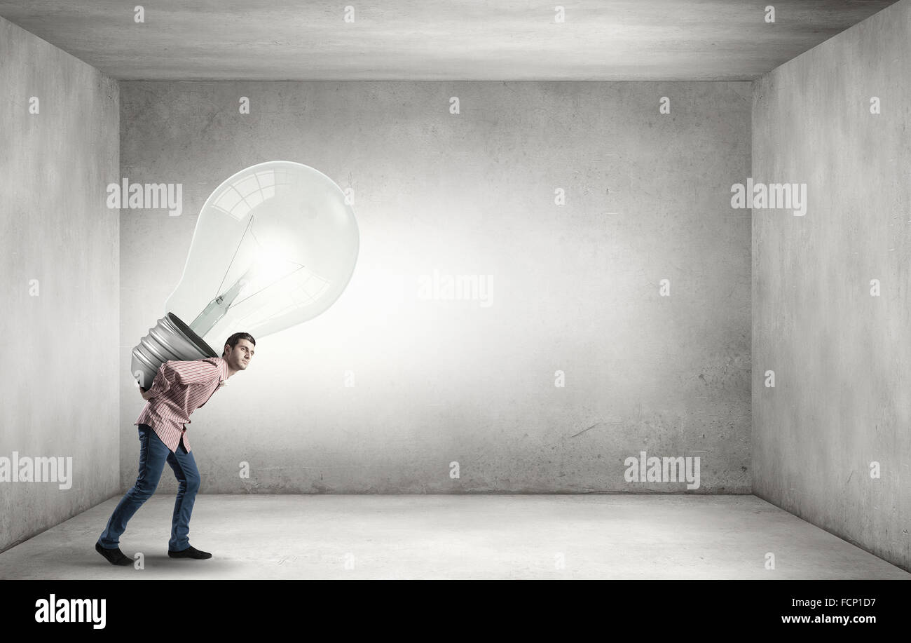 Young guy carrying light bulb on his back Stock Photo - Alamy