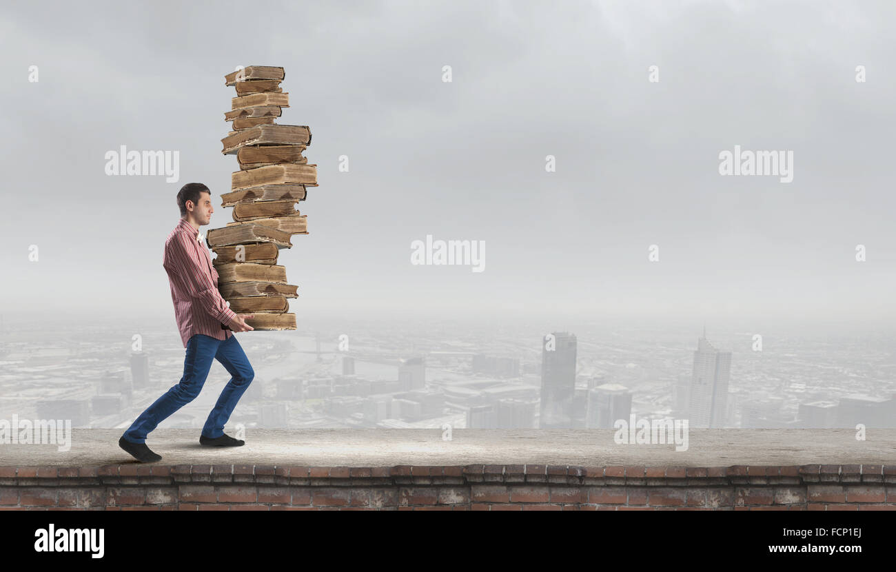 Man carrying stack old books hi-res stock photography and images - Alamy