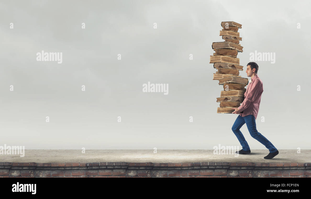 Man carrying stack old books hi-res stock photography and images - Alamy