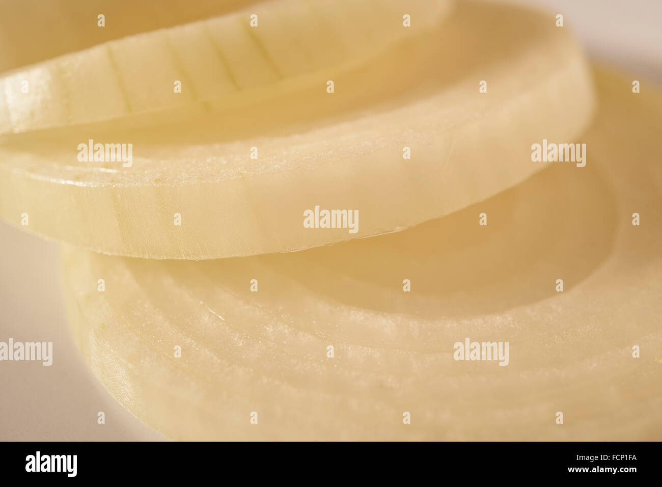 slices of fresh, raw yellow onion Stock Photo - Alamy
