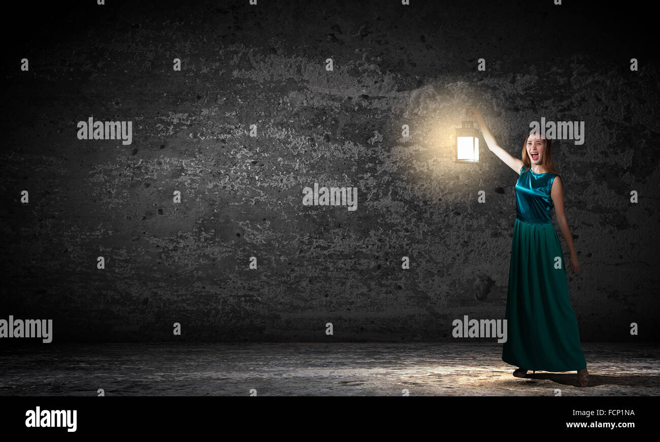 Young woman with lantern walking in darkness Stock Photo - Alamy
