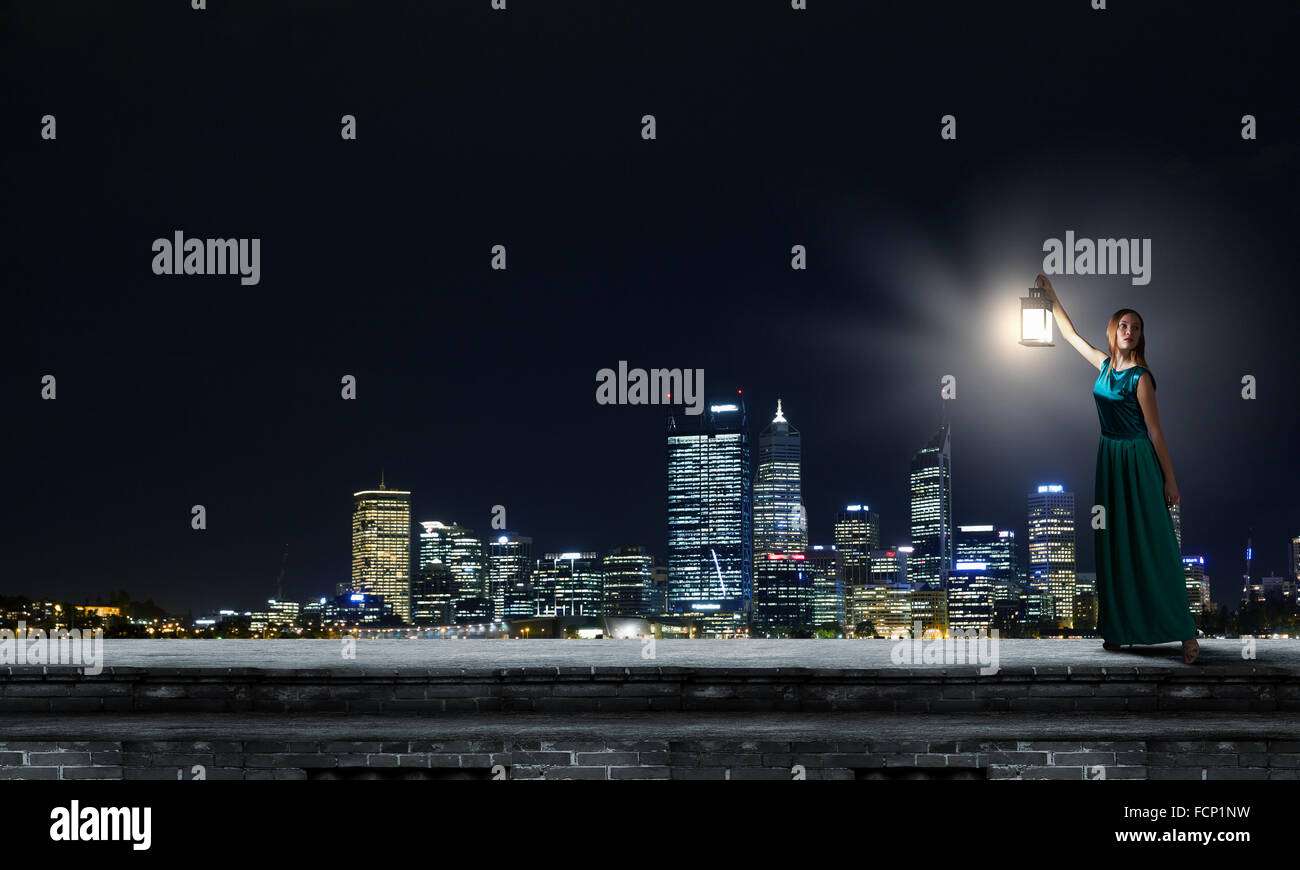 Young woman with lantern walking in darkness Stock Photo - Alamy