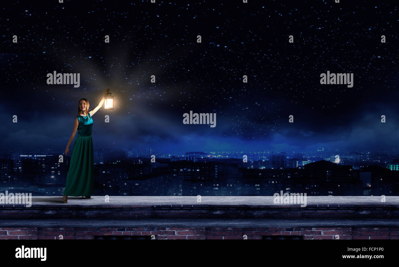 Young woman with lantern walking in darkness Stock Photo - Alamy