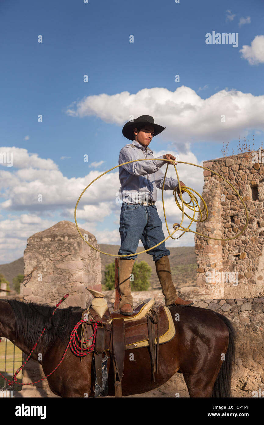 A Mexican charro or cowboy practices roping skills on his horse before ...